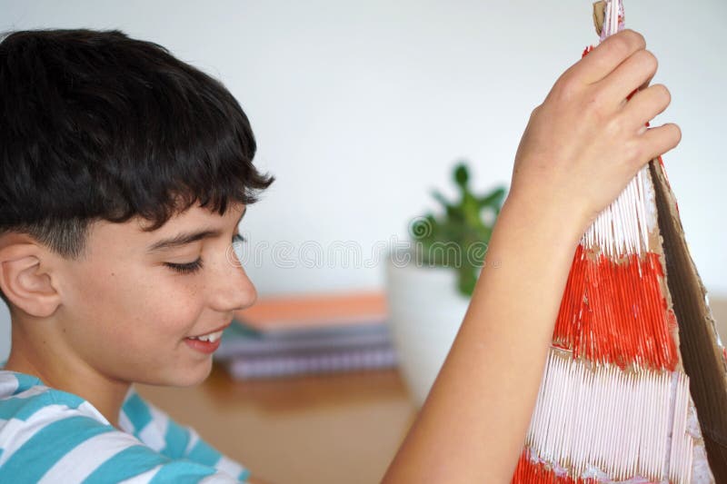 Boy Making Crafts Building a Tower with Sticks and Cardboard Stock ...