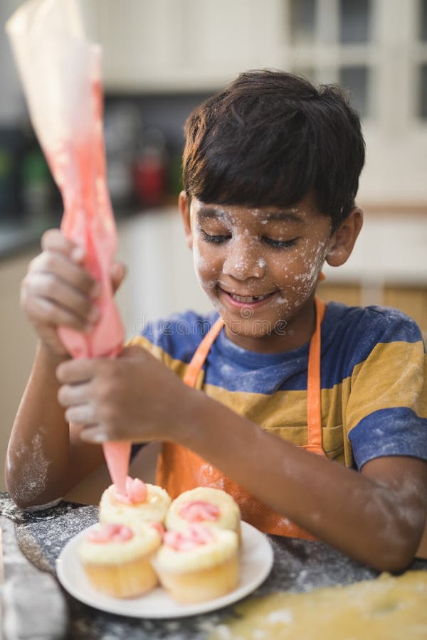 Boy Making Cup Cakes in Kitchen Stock Photo - Image of food, mixedrace ...