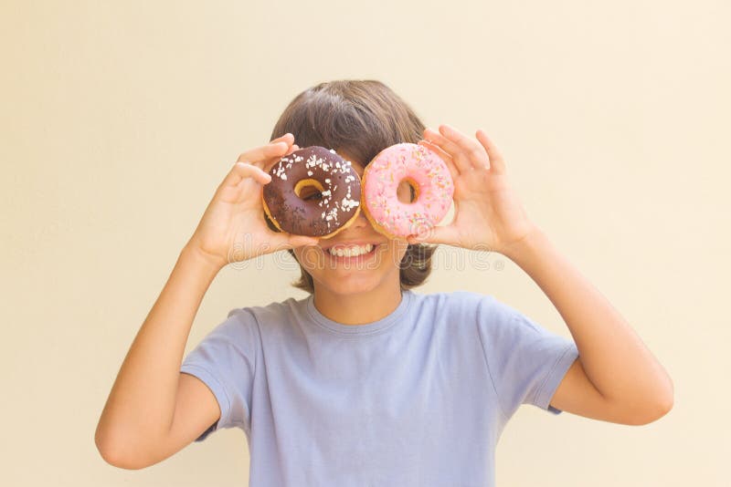 Boy making fun with donuts stock image. Image of happy - 32682213