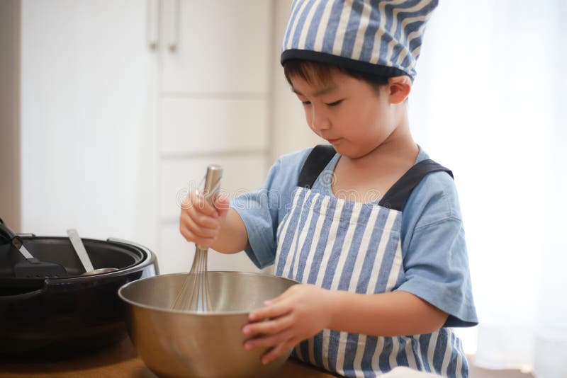 Boy making pancakes stock image. Image of whisk, copy - 248724719