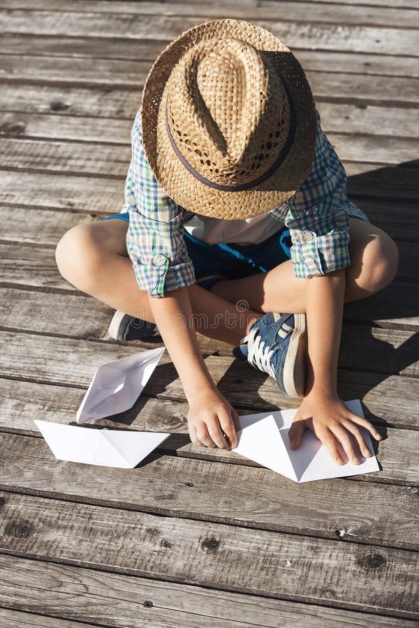 Boy Making a Paper Boats on the Wooden Pier Stock Image - Image of ...