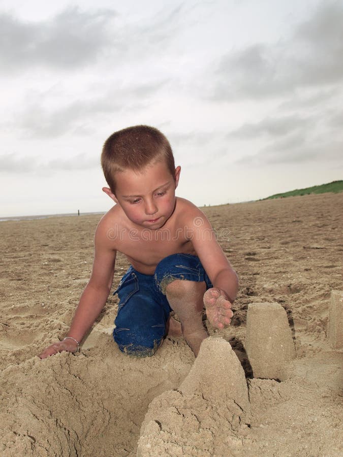Boy making sandcastle stock image. Image of enjoy, summer - 20651999