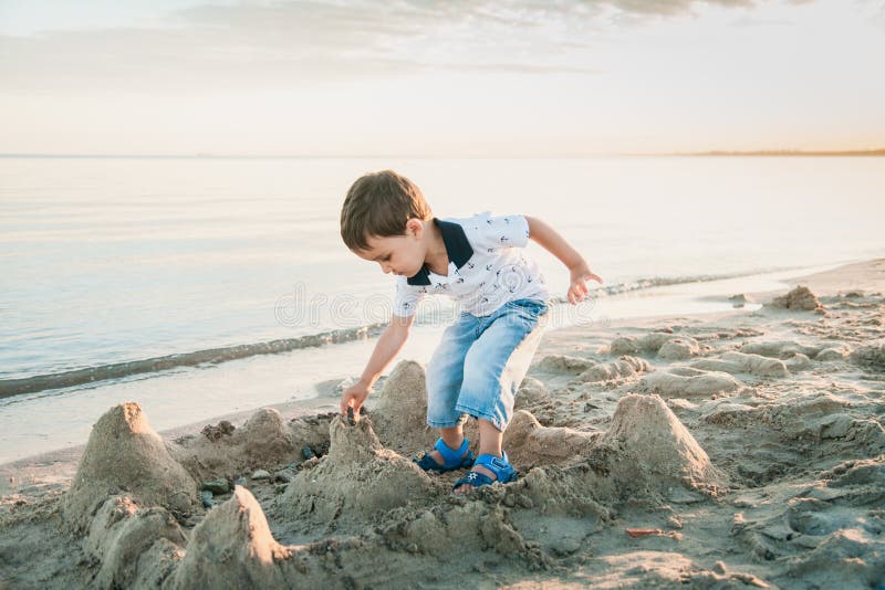 Boy Making Sandcastle on Beach Stock Image - Image of game, fortress ...