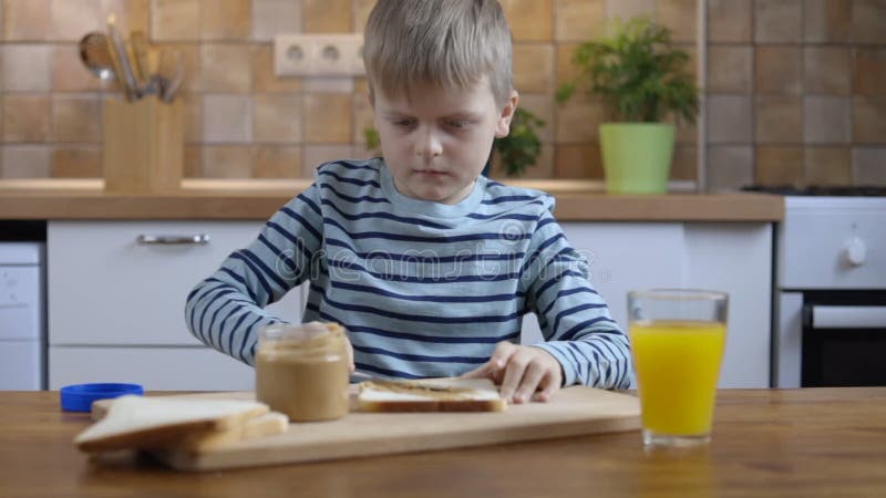 Boy Making a Sandwich with Peanut Butter on the Kitchen Stock Footage ...