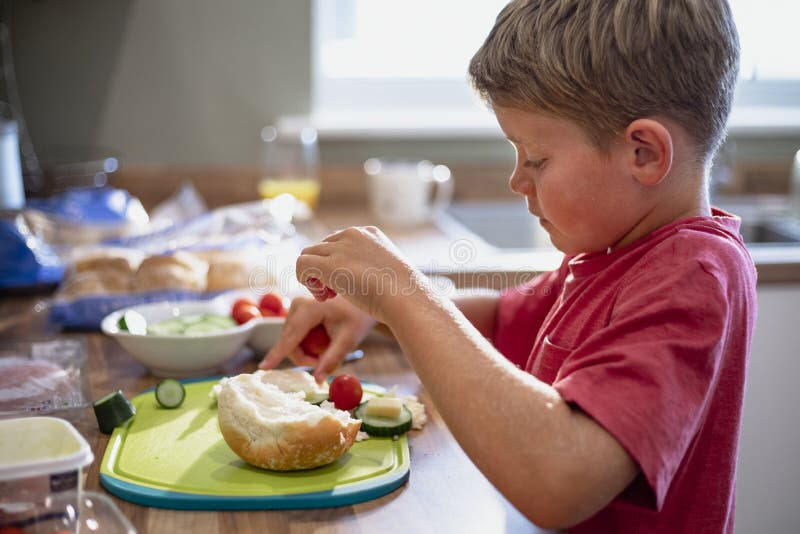 Boy Making a Sandwich stock image. Image of food, clothing - 174557379