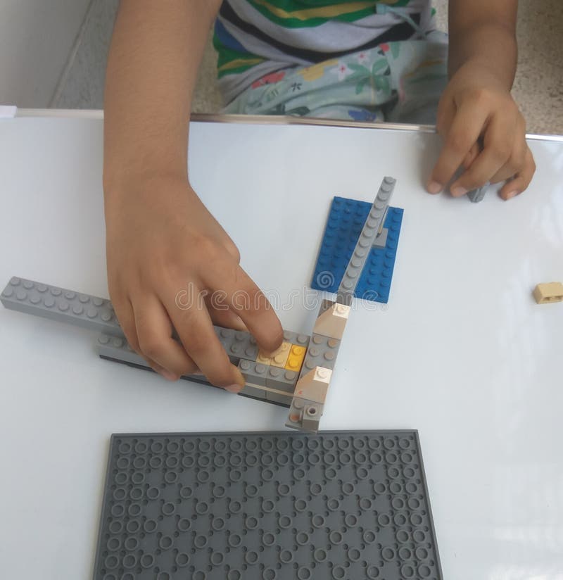 A Boy Making a Toy with Plastic Lego Blocks. Stock Photo - Image of ...