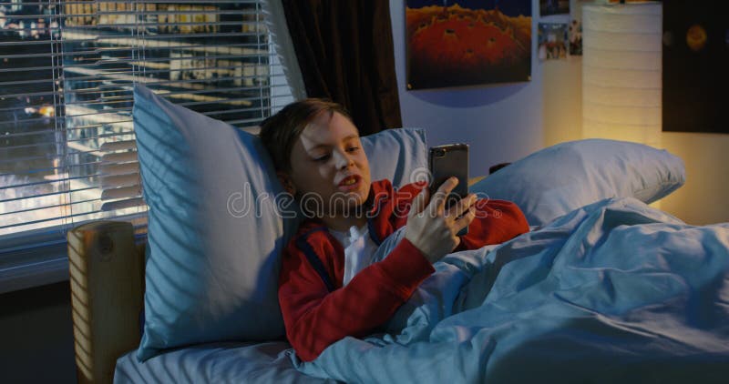 Boy Making a Call while Lying in Bed Stock Image - Image of digital ...