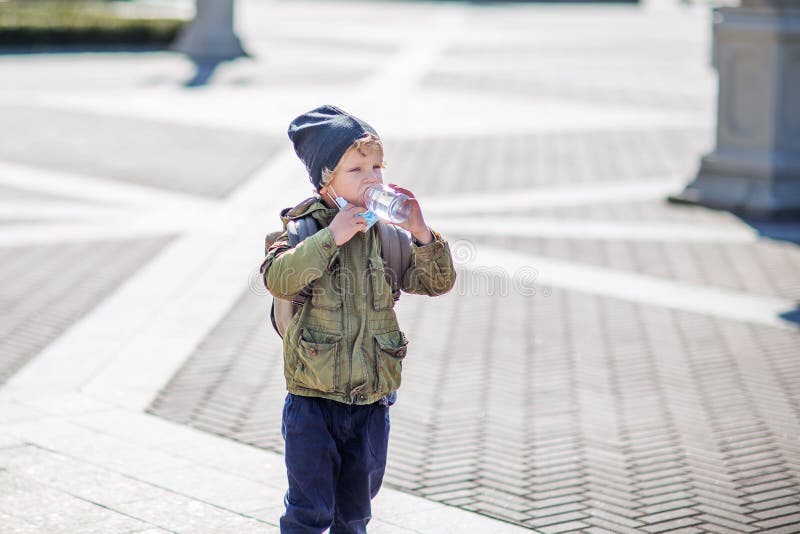 A Boy in Mask Holds a Bottle of Water in Hand Stock Image - Image of ...