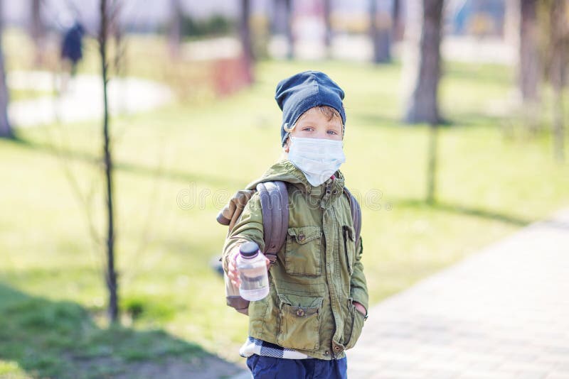 A Boy in Mask Holds a Bottle of Water in Hand Stock Image - Image of ...