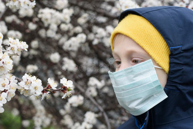 Boy in a Medical Protective Mask Outdoors. Flowering Tree, Spring Day ...