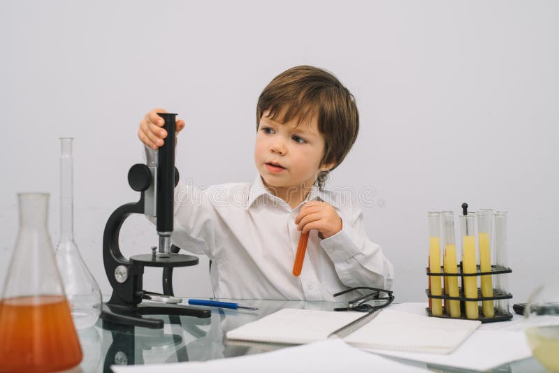 The Boy with a Microscope and Various Colorful Flasks on a White ...