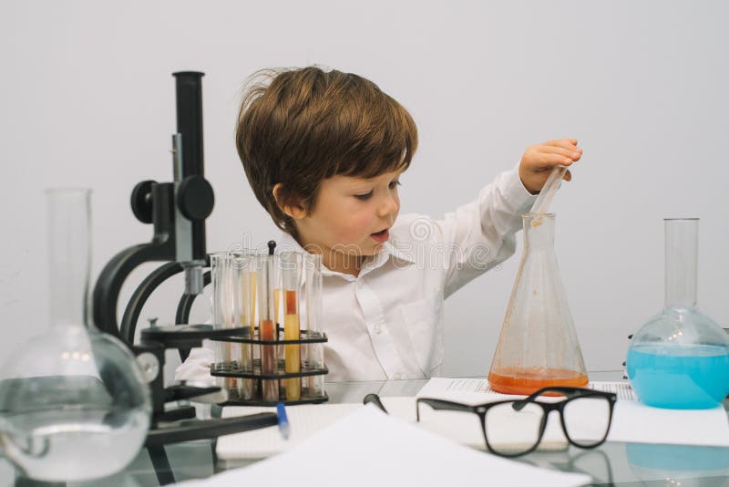 The Boy with a Microscope and Various Colorful Flasks on a White ...