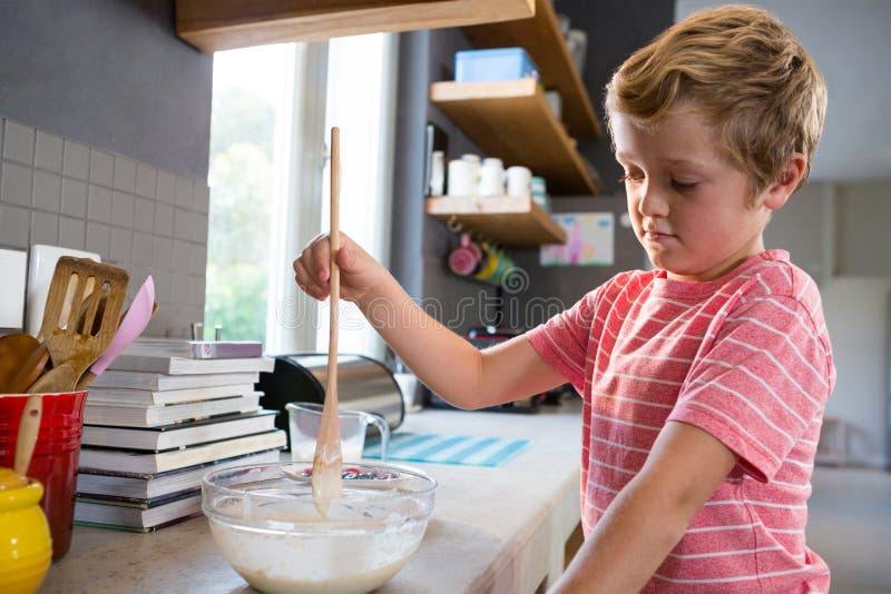 Boy Mixing Batter at Counter Stock Photo - Image of cute, house: 97401702