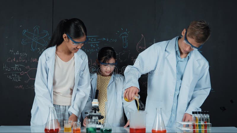 Boy Mixing Liquid in Beaker while Diverse Student Doing Experiment ...