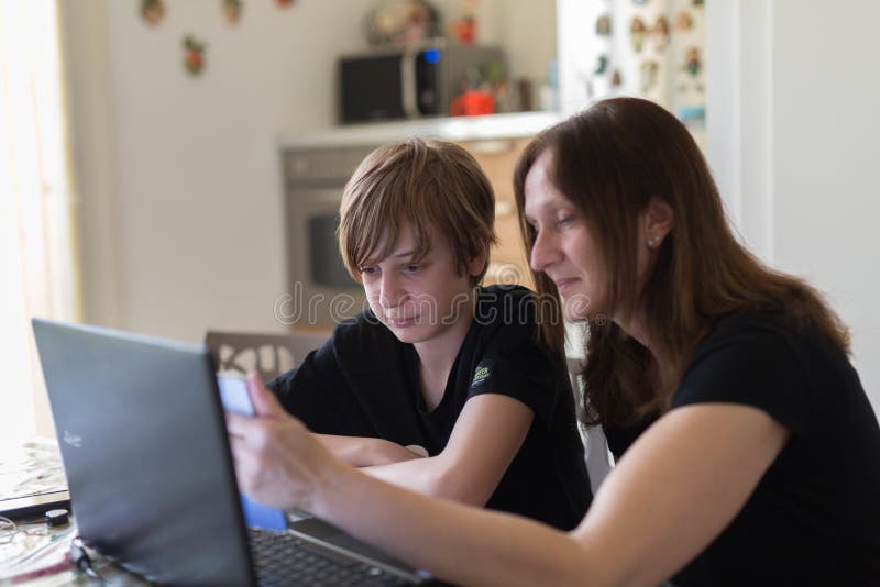 Boy with Mom in Front of Laptop and Smartphone Making a Video Call ...