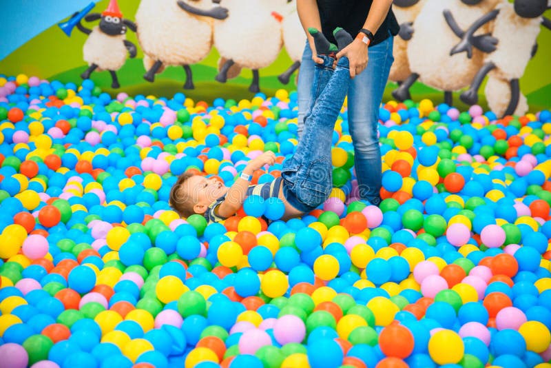 A Boy with Mother in the Playing Room with Many Little Colored Balls ...