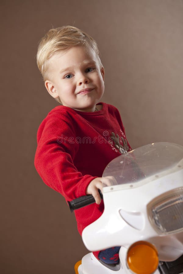 Boy on motorcycle stock photo. Image of hand, cheerful - 28575362