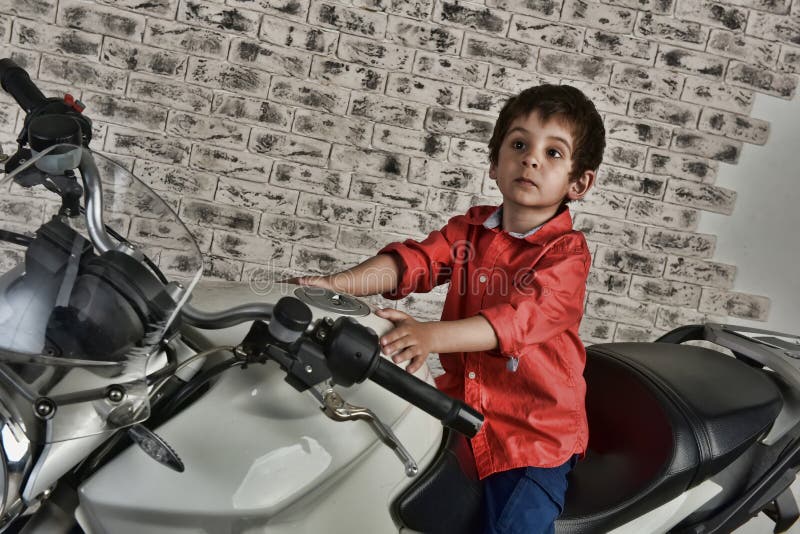 Boy and a motorcycle stock photo. Image of cute, insurance - 92602148
