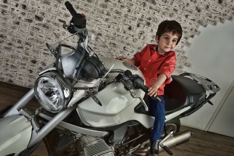 Boy and a motorcycle stock photo. Image of childhood - 92602150