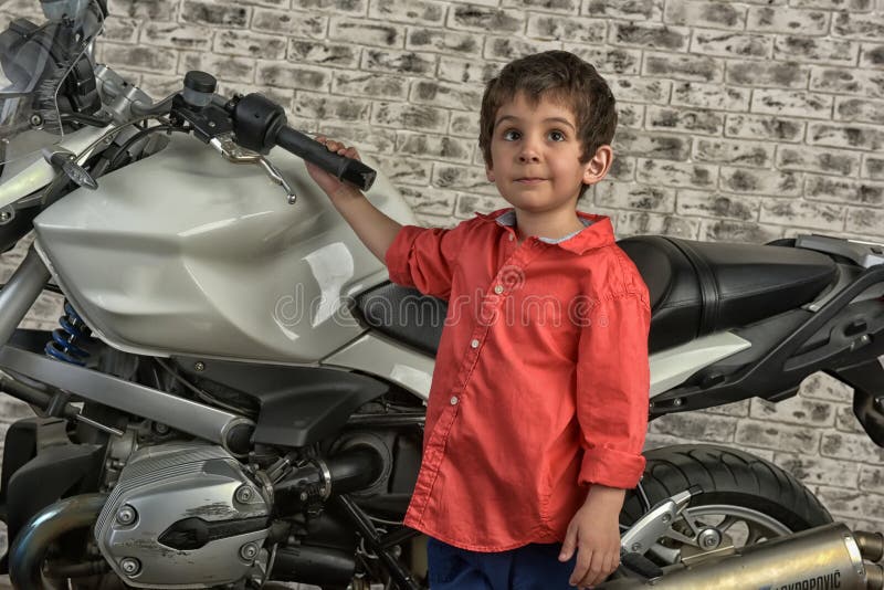 Boy and a motorcycle stock photo. Image of funny, jacket - 92602274