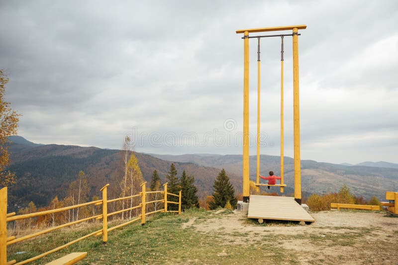 Boy in the Mountains on a Big Swing Stock Image - Image of summer ...