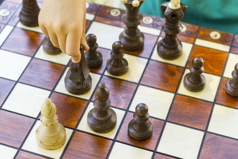 Boy moving a knight stock image. Image of game, king - 76745069