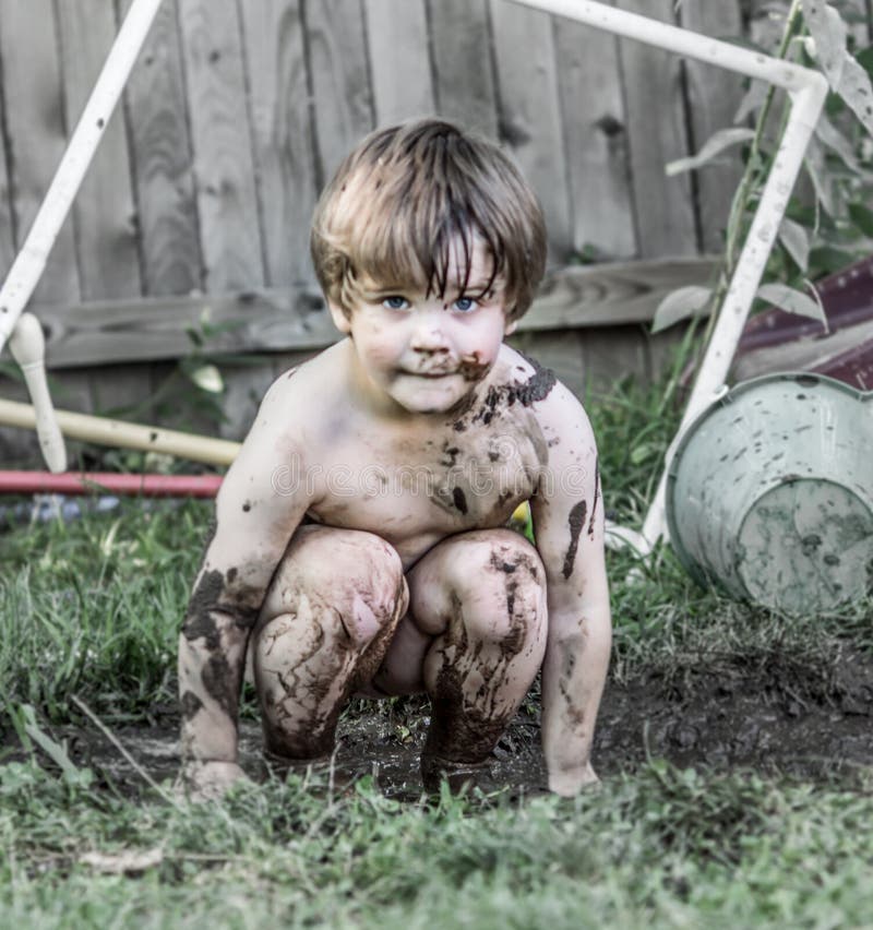 Boy in mud stock image. Image of background, male, grass - 84415039