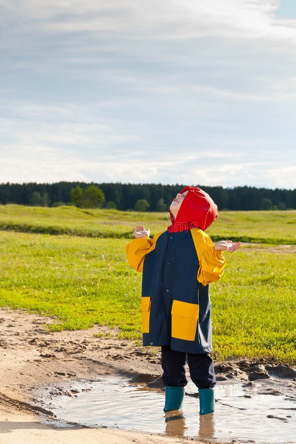 Boy in a muddy puddle stock image. Image of field, hood - 25114693