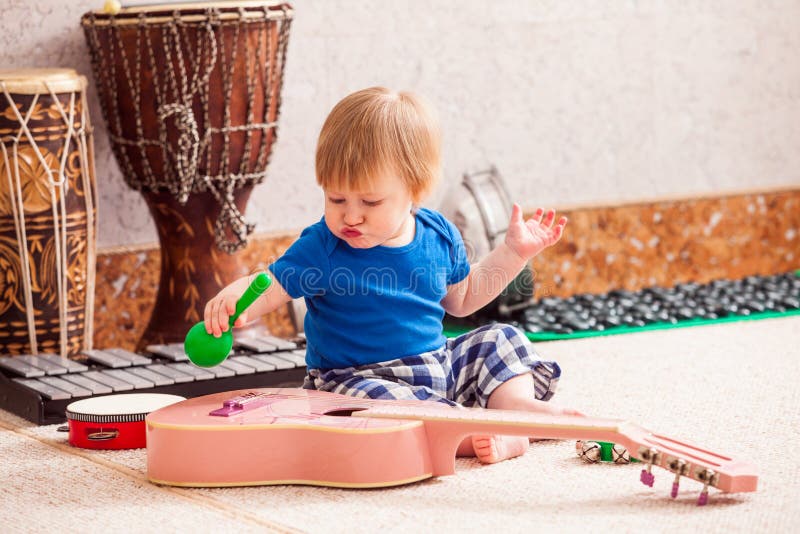 Boy with Musical Instruments Stock Image - Image of education, indoor ...