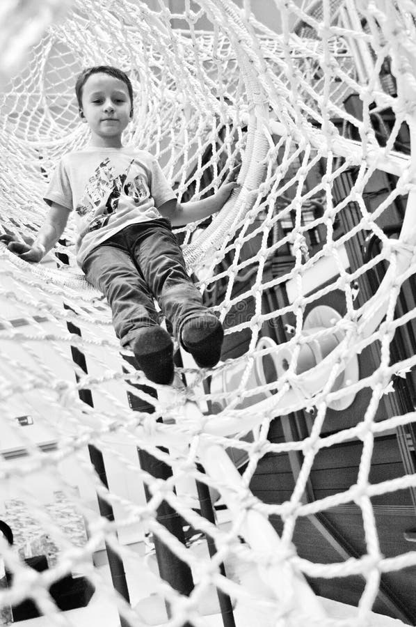 Boy in Net Sleeve of Amusement Park Climbing Facility Stock Image ... Boy in Net Sleeve of Amusement Park Climbing Facility Stock Image ...