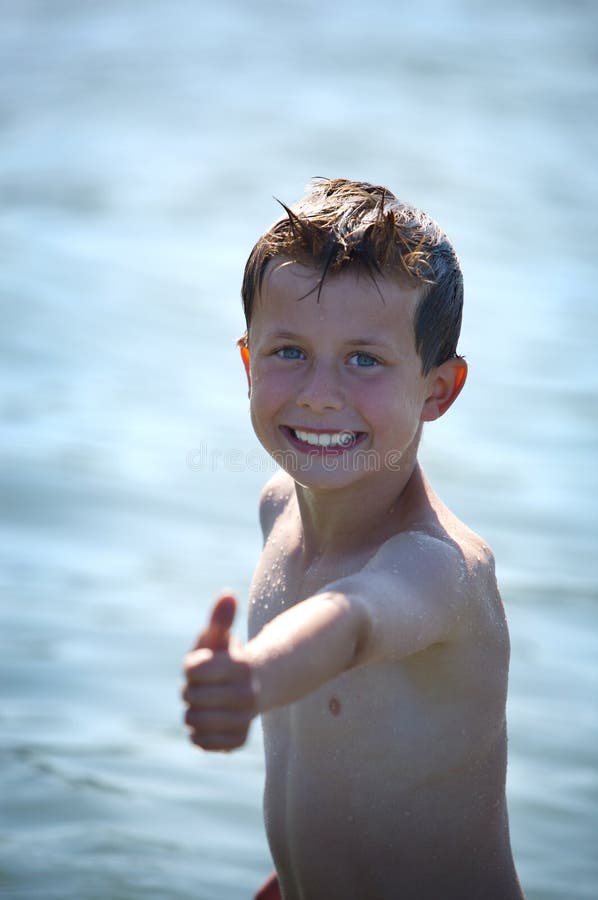 Boy in ocean stock photo. Image of sunny, beach, standing - 15464258