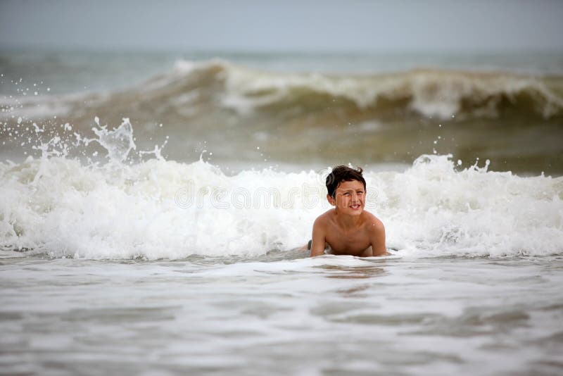 Boy in waves in ocean stock image. Image of nature, ocean - 34814001