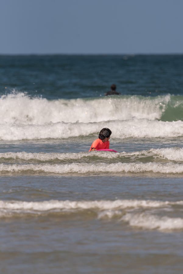 Boy with Orange Equipment and Bodyboard Practices in the Waves of ...