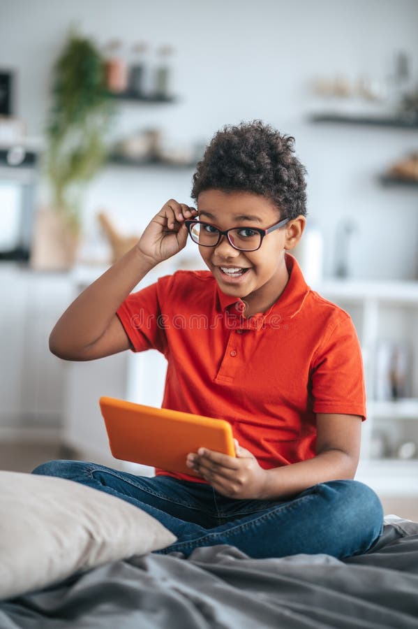 Boy in Orange Tshirt Looking Excited while Watching Something Online ...