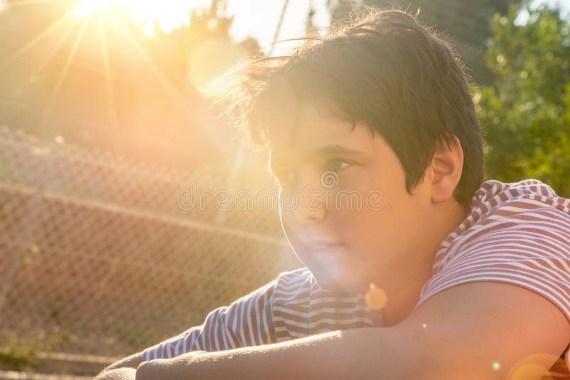 Boy outdoors at sunset stock image. Image of summer - 233691781