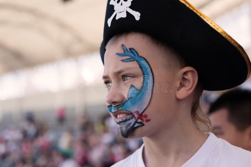 Boy Painting Face in Pirate Hat Stock Image - Image of smile, child ...