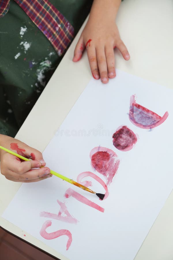 Boy Painting Name on Paper in Art Class Stock Photo - Image of high ...