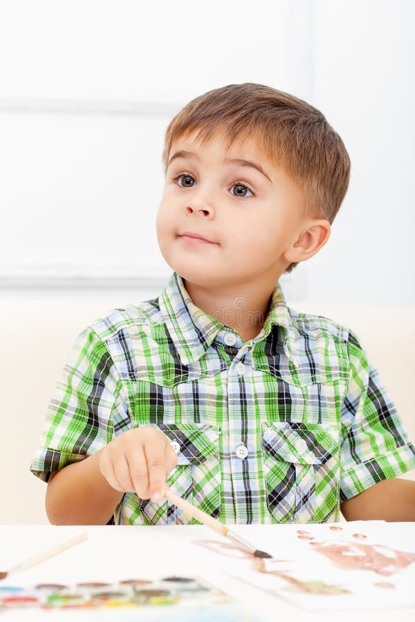 Boy is painting something stock image. Image of smiling - 35634313