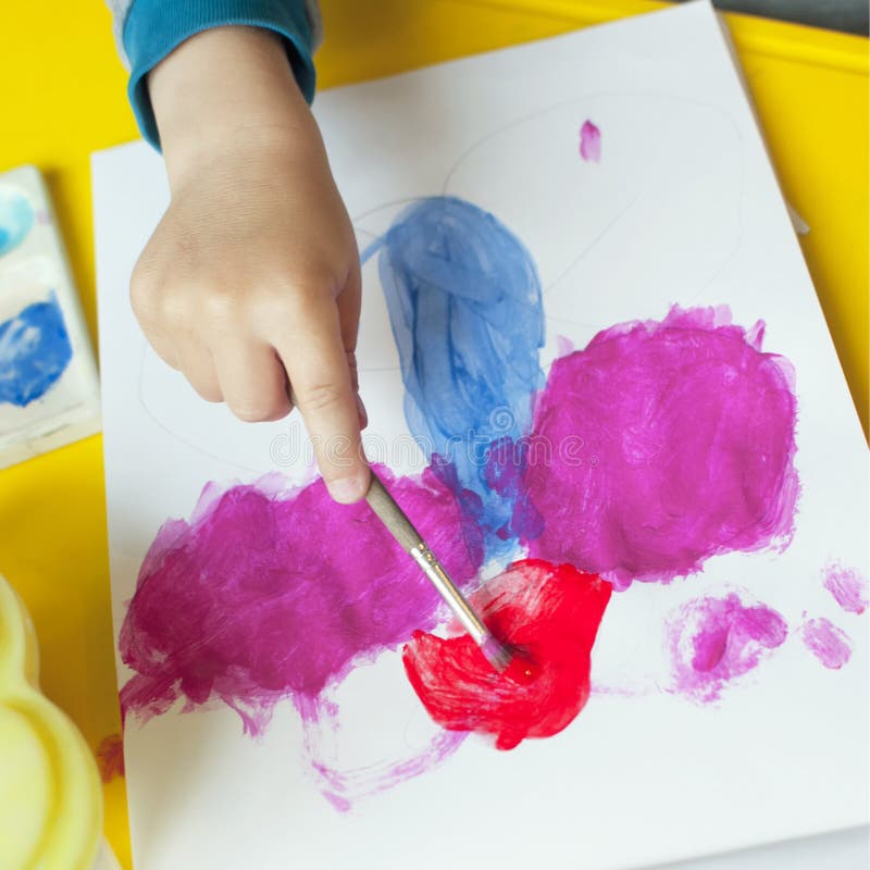 A Boy Paints A Drawing On A Piece Of Paper Stock Photo - Image of small ...