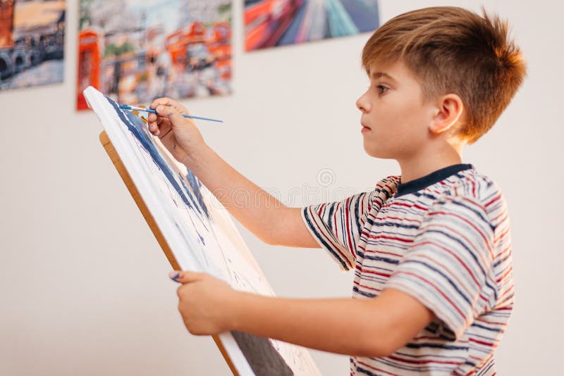 A Boy Paints a Picture on an Easel Brush and Paints Stock Image - Image ...