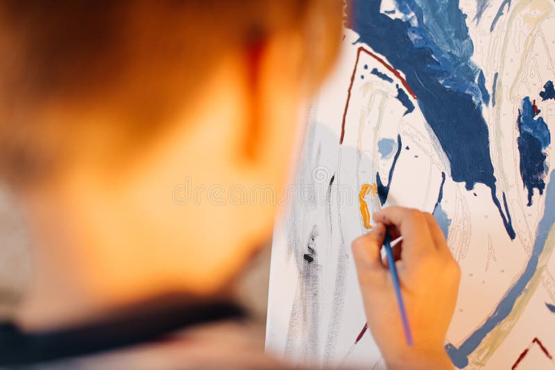 A Boy Paints a Picture with Numbers with a Brush with Paints Stock ...