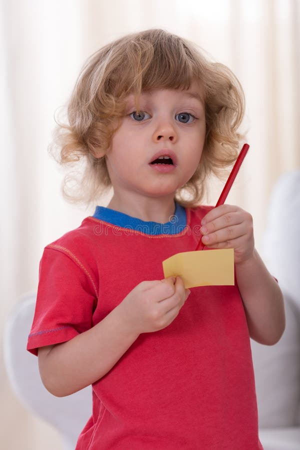 Boy with paper and pen stock image. Image of childhood - 62911299