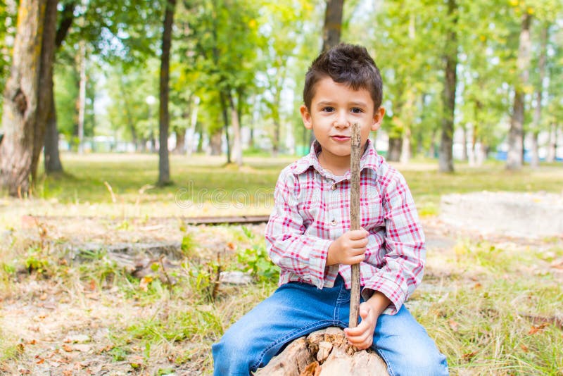Boy Sitting on a Log in Forest Stock Image - Image of happiness ...