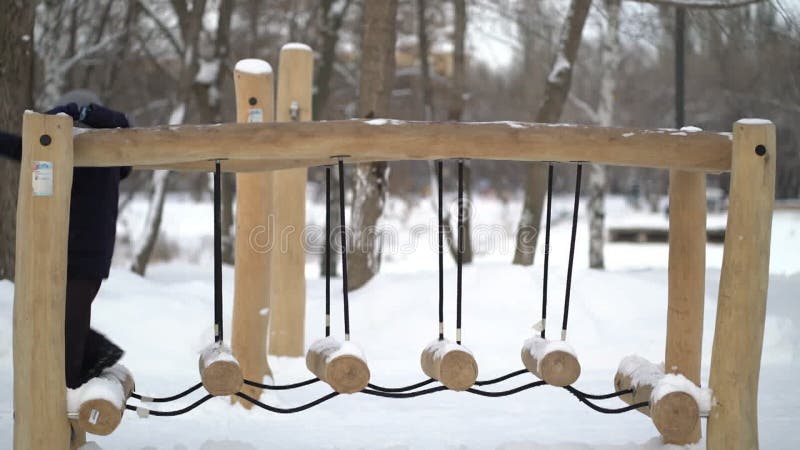 Boy Passing Obstacle Course Attraction in Playground in Winter. Stock ...