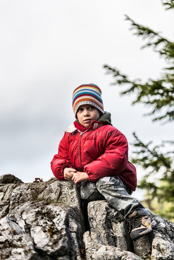 Boy on Peak Looking Curious Stock Image - Image of rocky, curious: 30830549