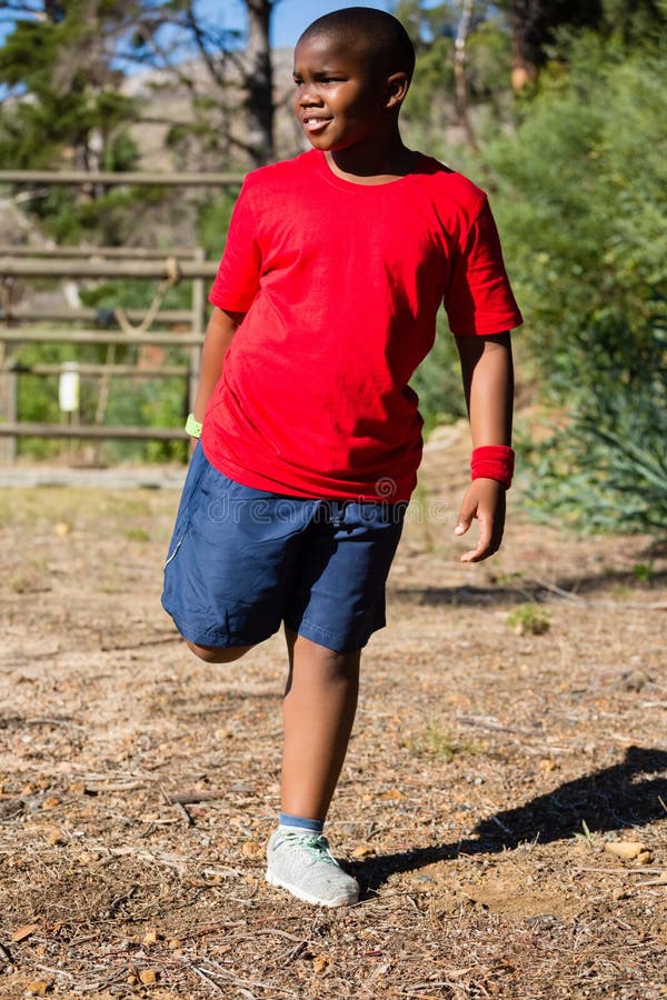 Boy Performing Stretching Exercise during Obstacle Course Training ...