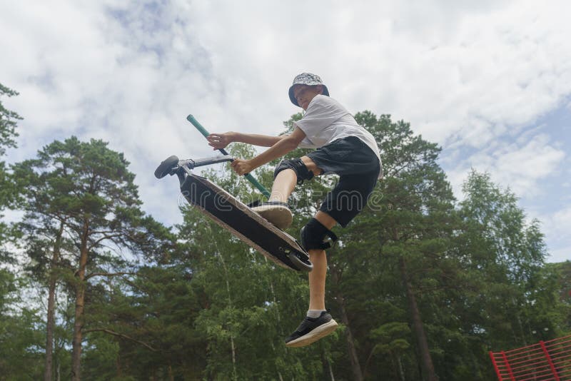 Boy Performs Extreme Stunts Jumping with a Scooter, Extreme Sports ...