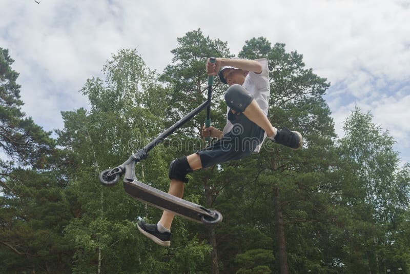 Boy Performs Extreme Stunts Jumping with a Scooter, Extreme Sports ...