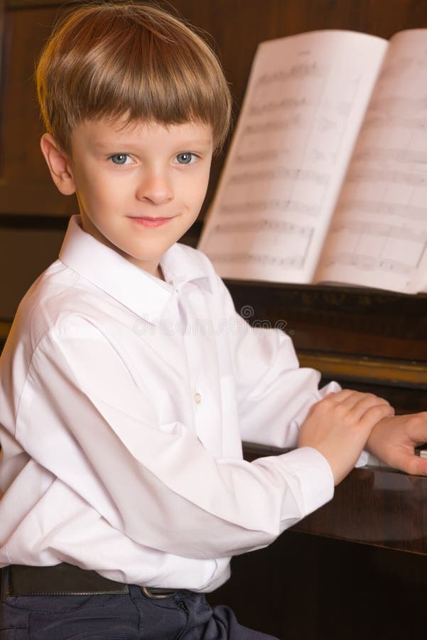 Boy piano. Piano player. stock image. Image of note, childhood - 65884599