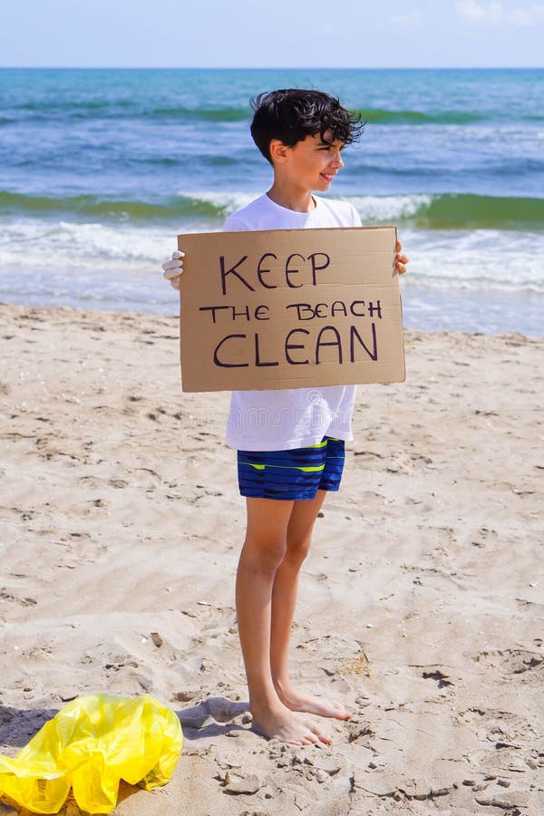 Boyon the Beach and Holding Up a Sign Saying KEEP the BEACH CLEAN Stock ...